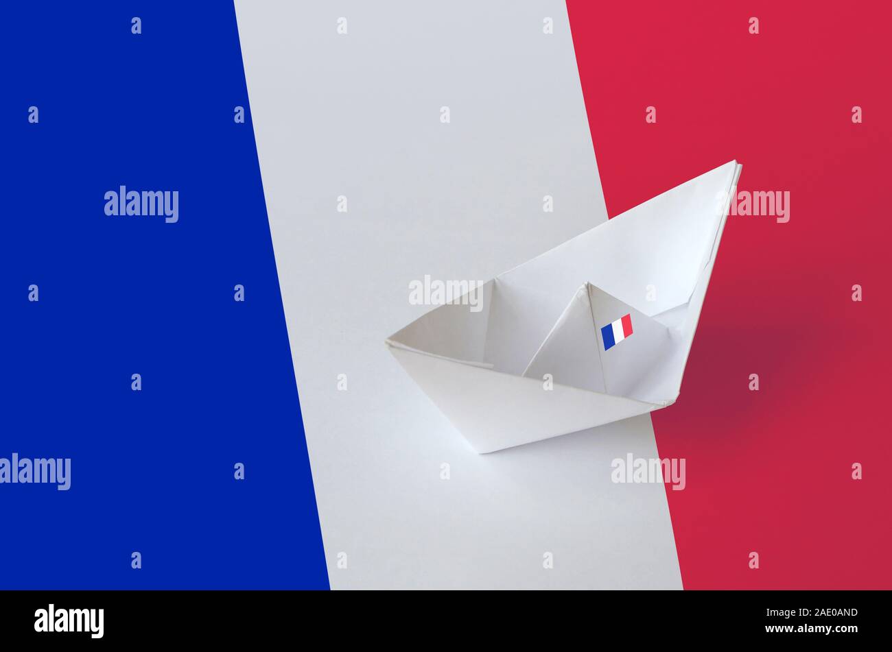 France flag depicted on paper origami ship closeup. Oriental handmade ...