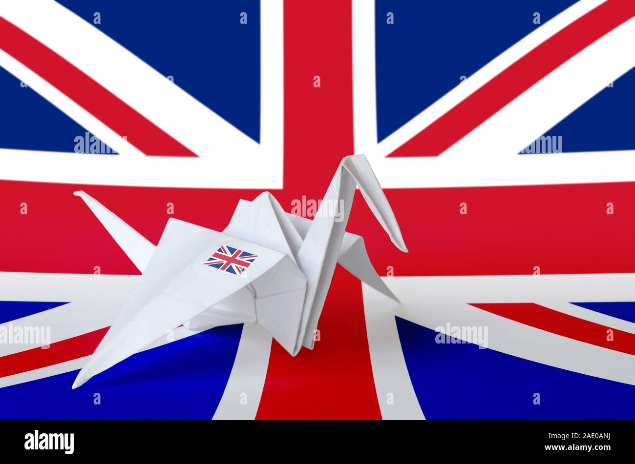 Great britain flag depicted on paper origami crane wing. Oriental ...