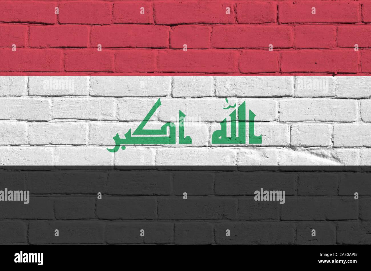 Iraq flag depicted in paint colors on old brick wall close up. Textured ...