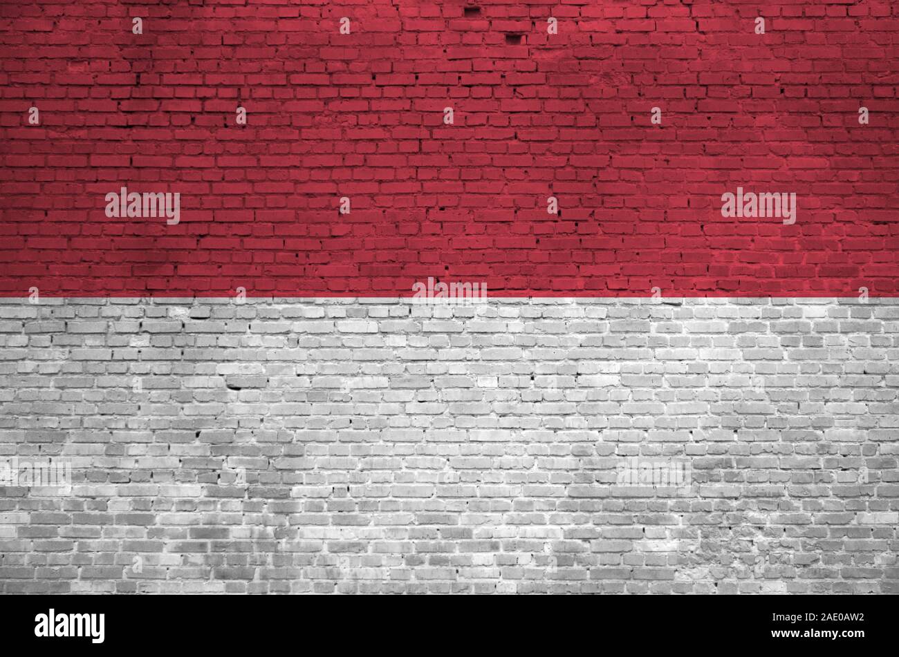Monaco flag depicted in paint colors on old brick wall close up ...