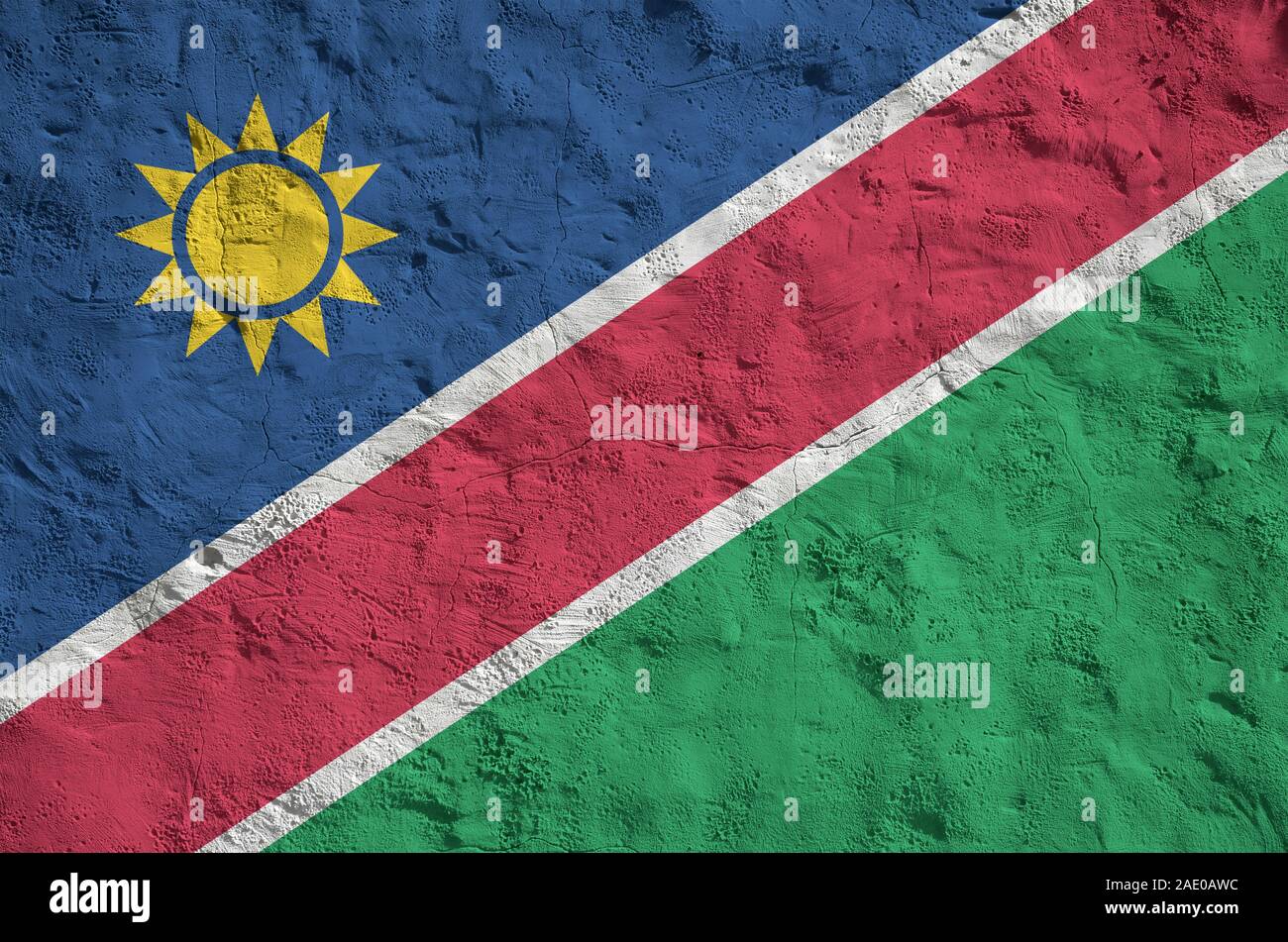 Namibia flag depicted in bright paint colors on old relief plastering ...