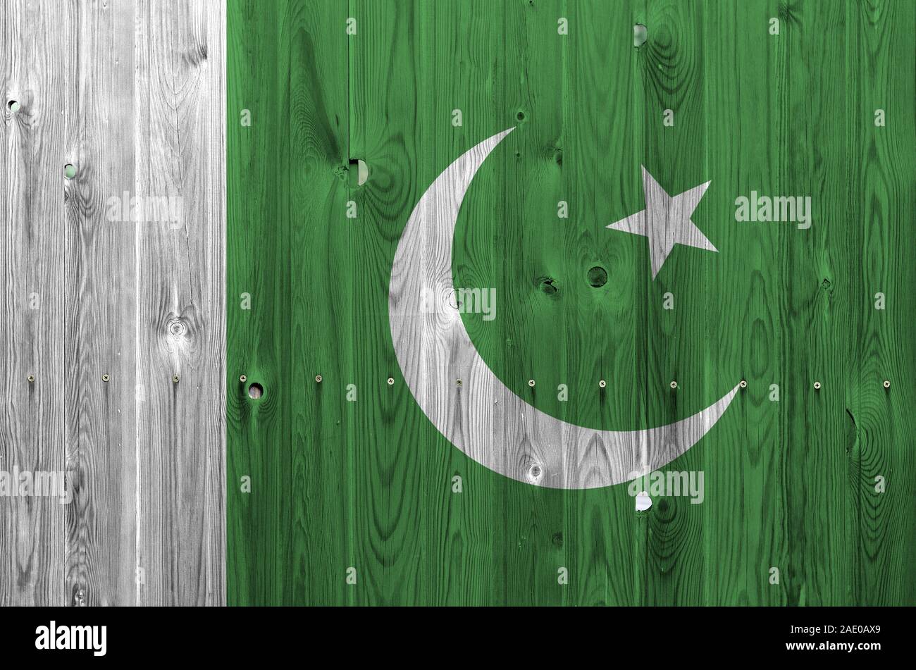 Pakistan flag depicted in bright paint colors on old wooden wall close ...