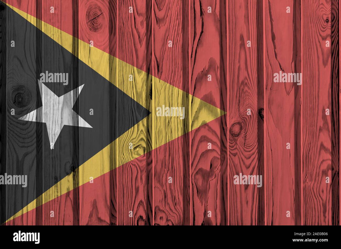 Timor Leste flag depicted in bright paint colors on old wooden wall ...