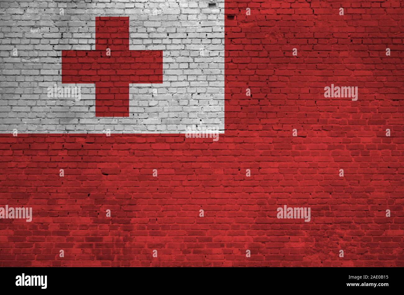 Tonga flag depicted in paint colors on old brick wall close up ...