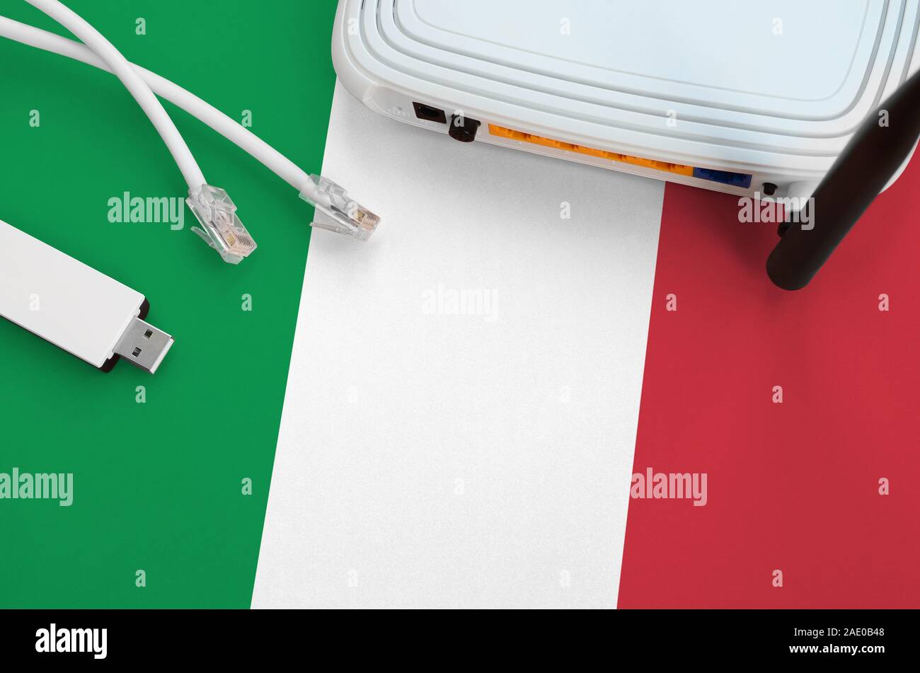Italy flag depicted on table with internet rj45 cable, wireless usb wi ...