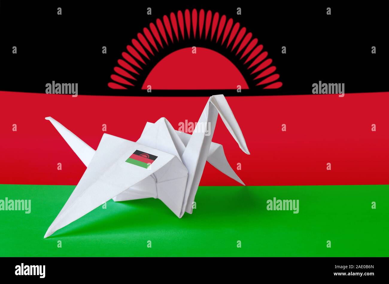 Malawi flag depicted on paper origami crane wing. Oriental handmade ...