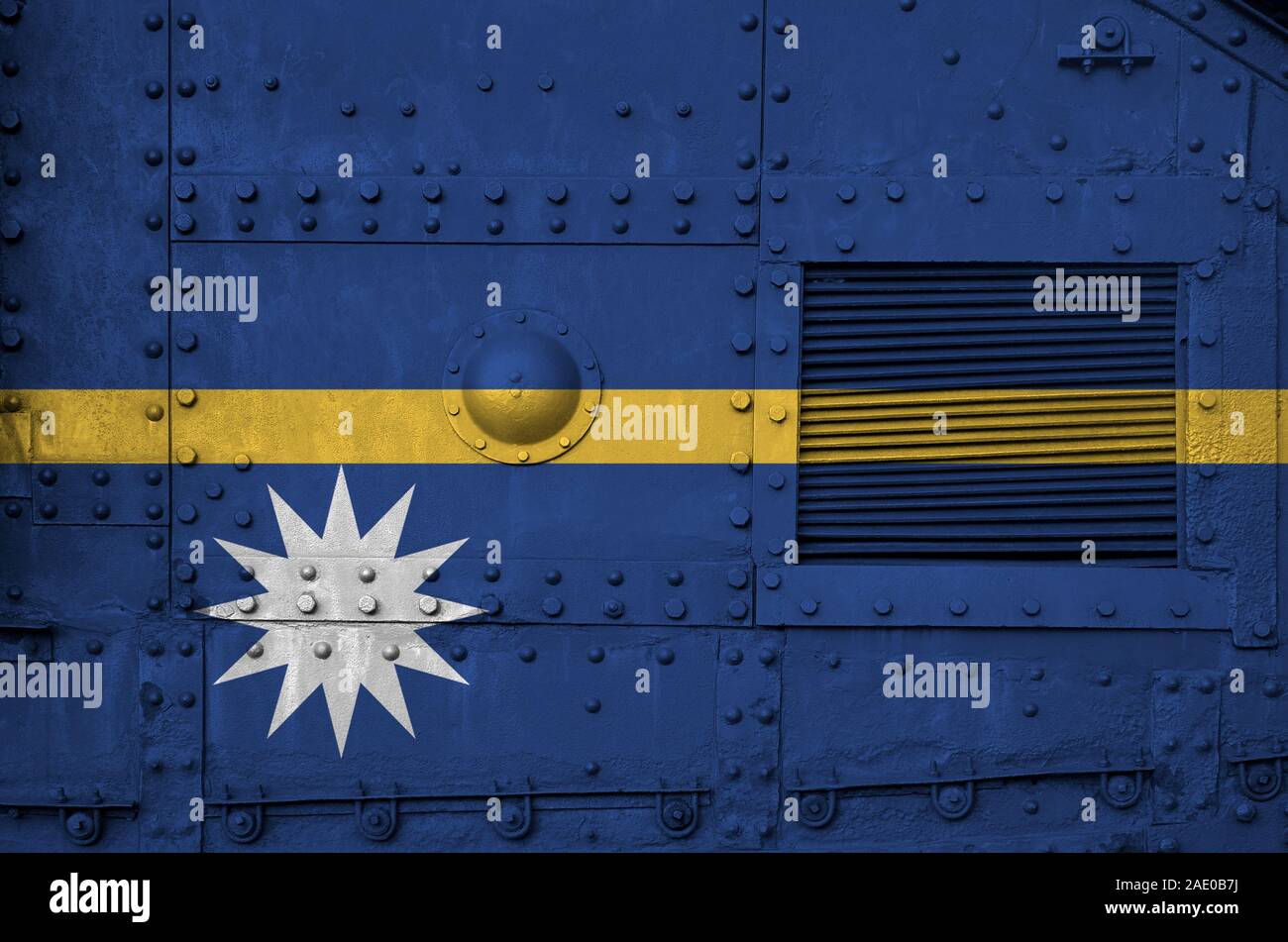 Nauru flag depicted on side part of military armored tank close up ...