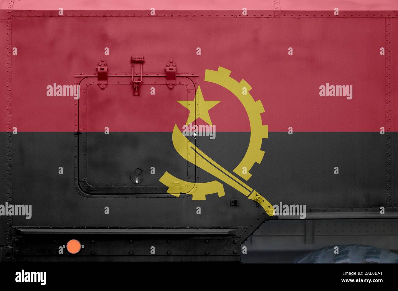 Angola flag depicted on side part of military armored truck close up ...