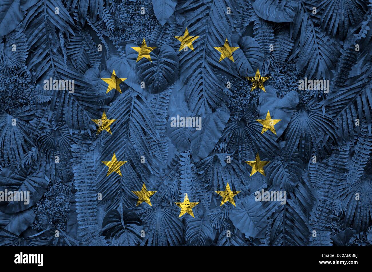 European union flag depicted on many leafs of monstera palm trees ...