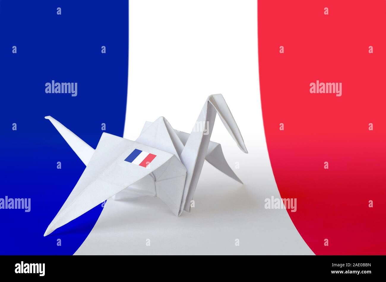 France flag depicted on paper origami crane wing. Oriental handmade ...