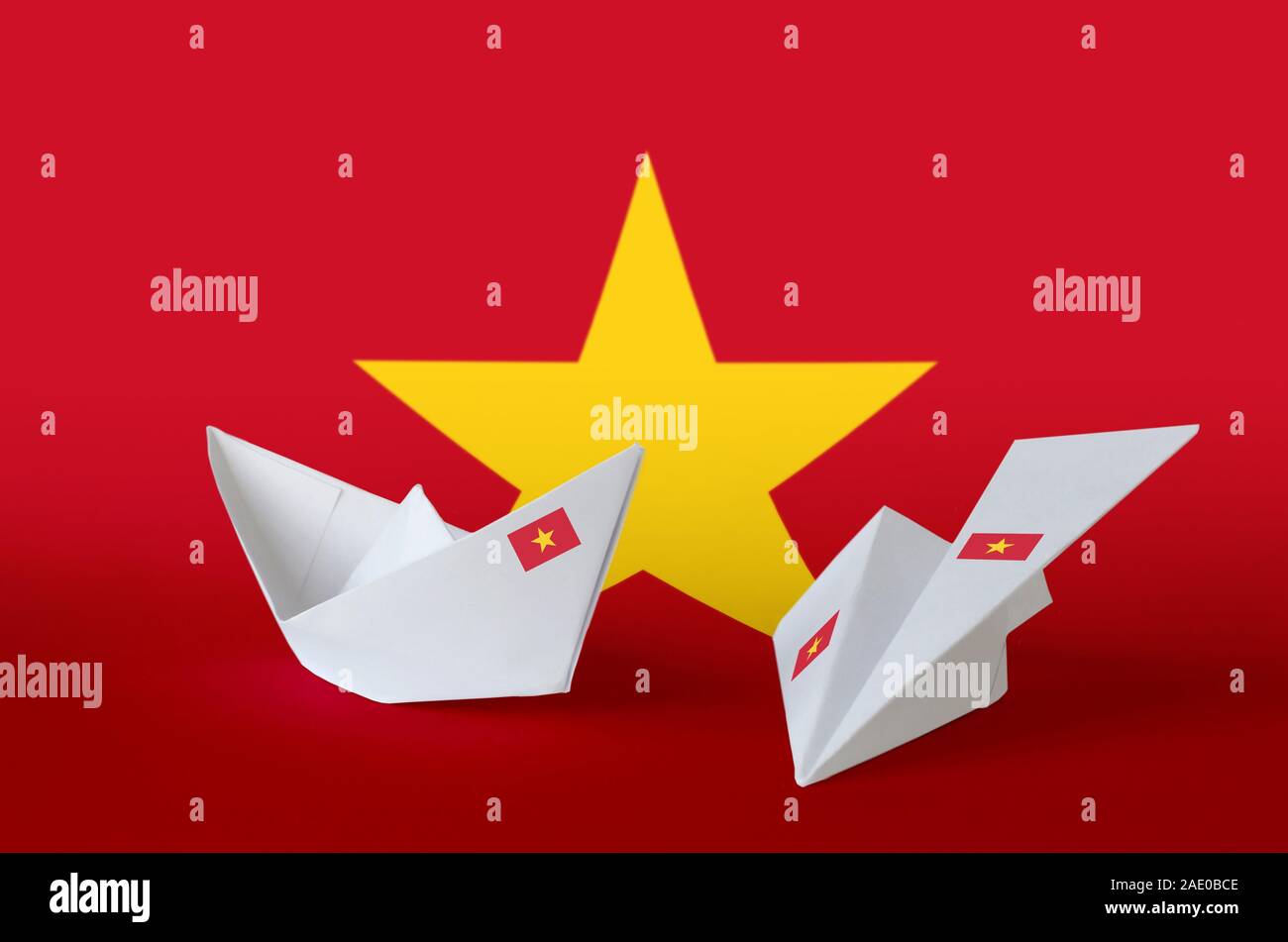 Vietnam flag depicted on paper origami airplane and boat. Oriental ...