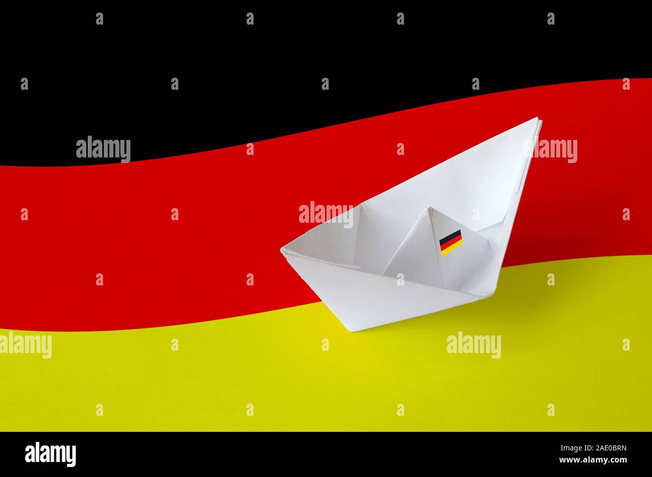 Germany flag depicted on paper origami ship closeup. Oriental handmade ...
