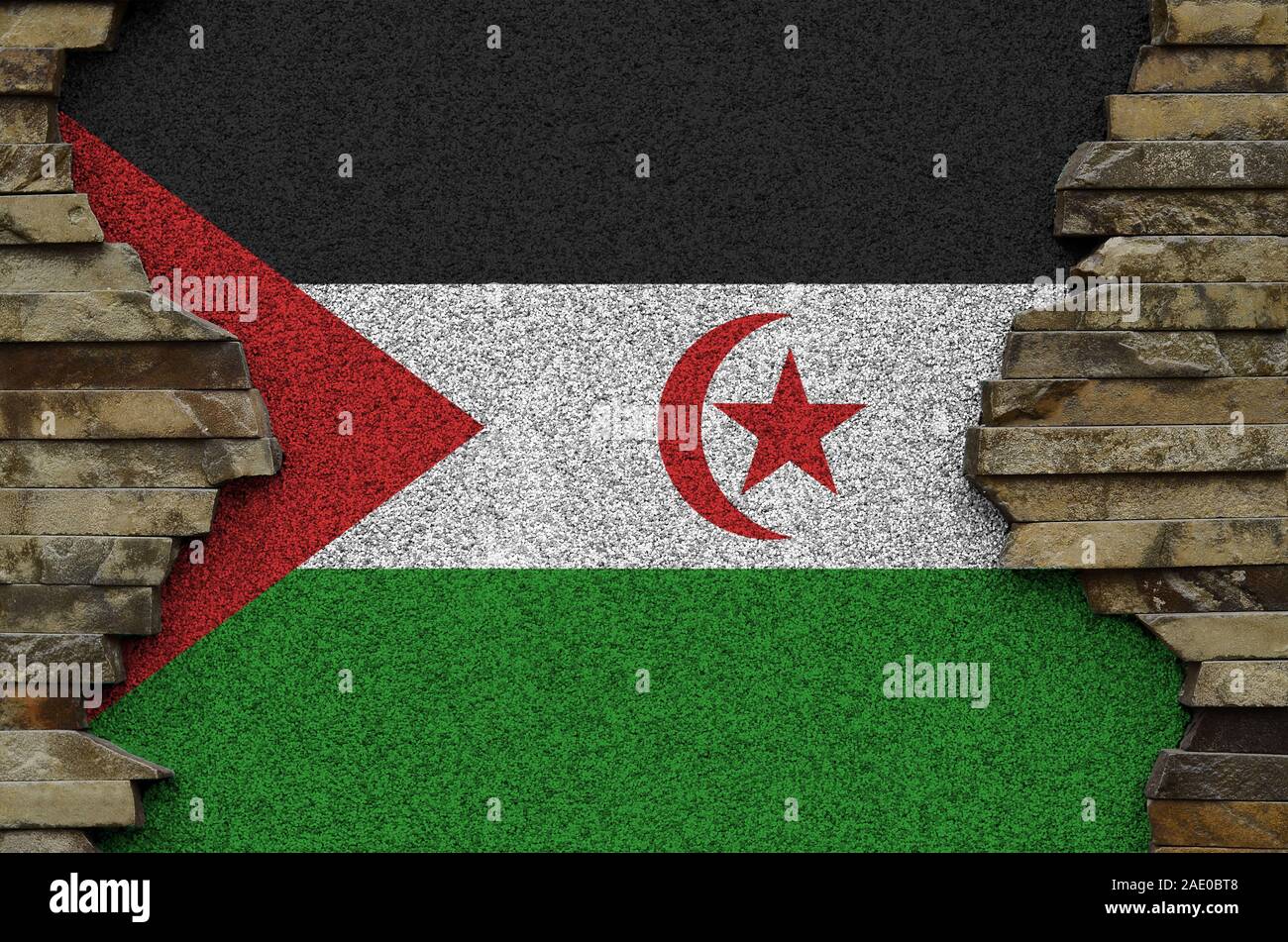 Western Sahara flag depicted in paint colors on old stone wall close up ...