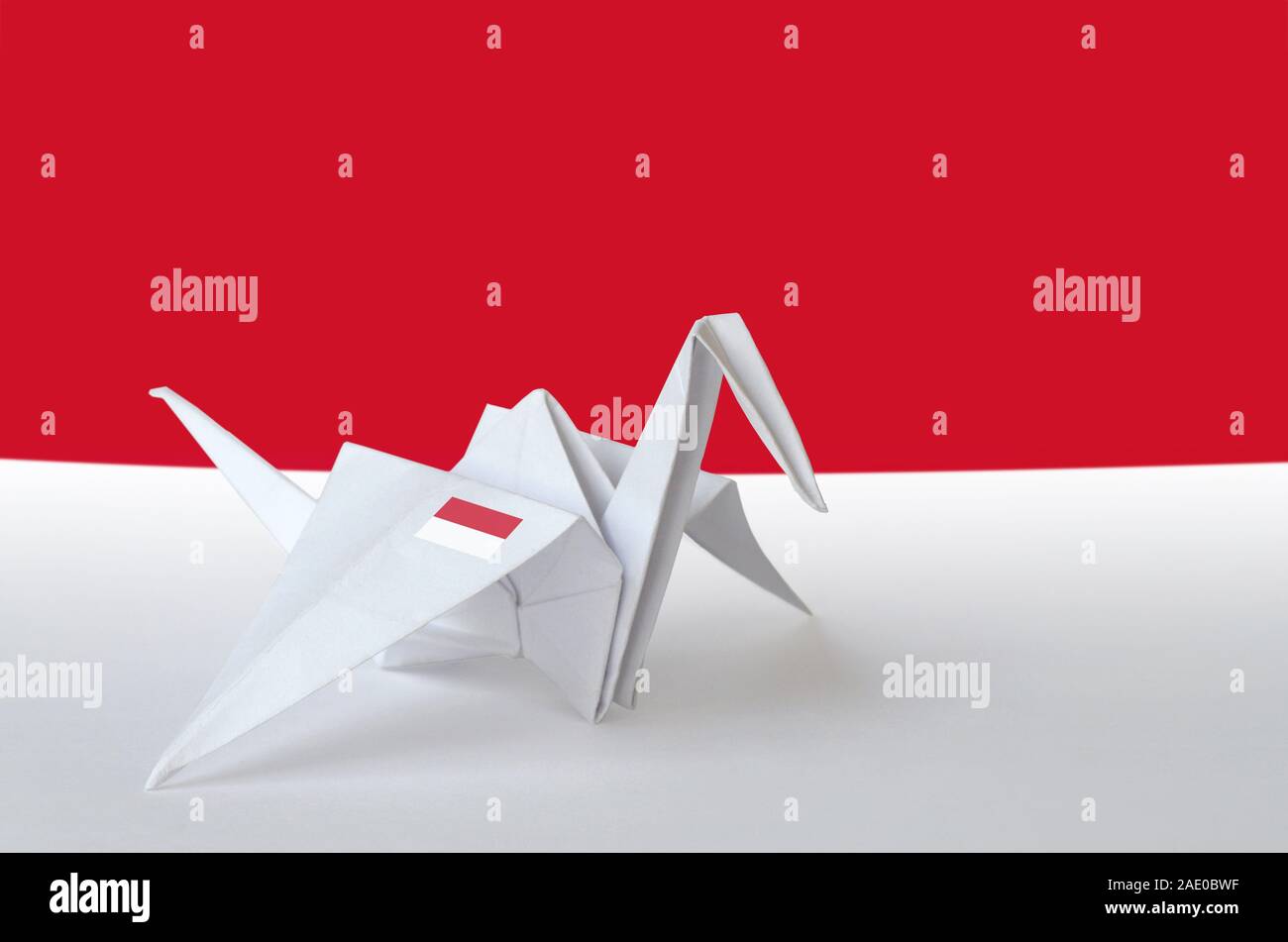 Indonesia flag depicted on paper origami crane wing. Oriental handmade ...