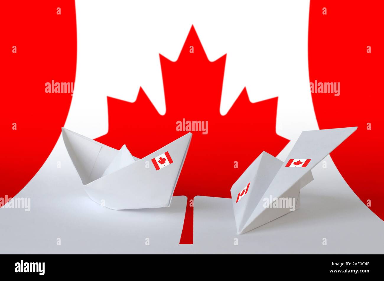 Canada flag depicted on paper origami airplane and boat. Oriental ...