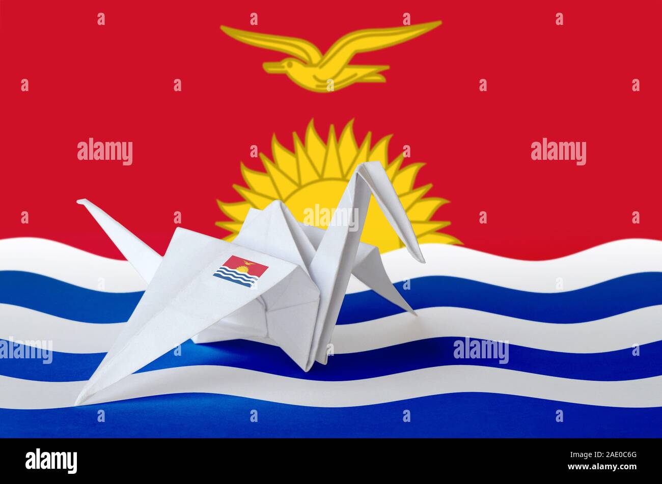 Kiribati flag depicted on paper origami crane wing. Oriental handmade ...