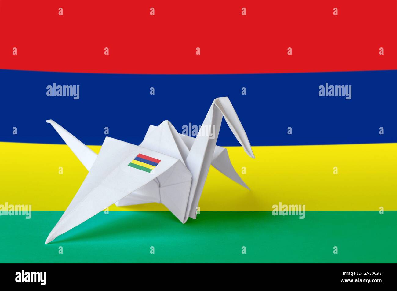 Mauritius flag depicted on paper origami crane wing. Oriental handmade ...
