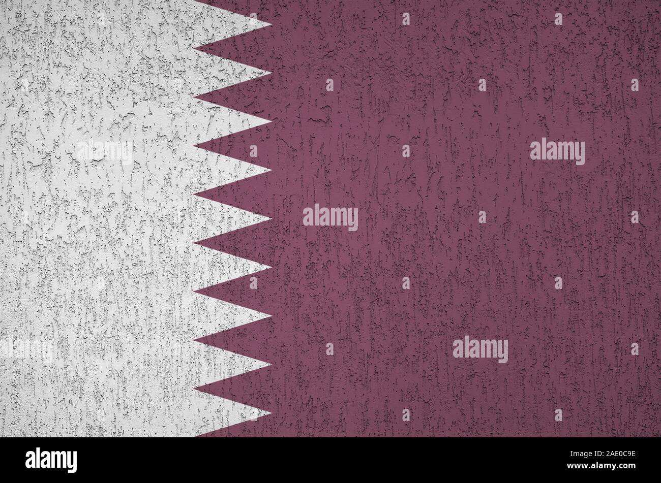 Qatar flag depicted in bright paint colors on old relief plastering ...