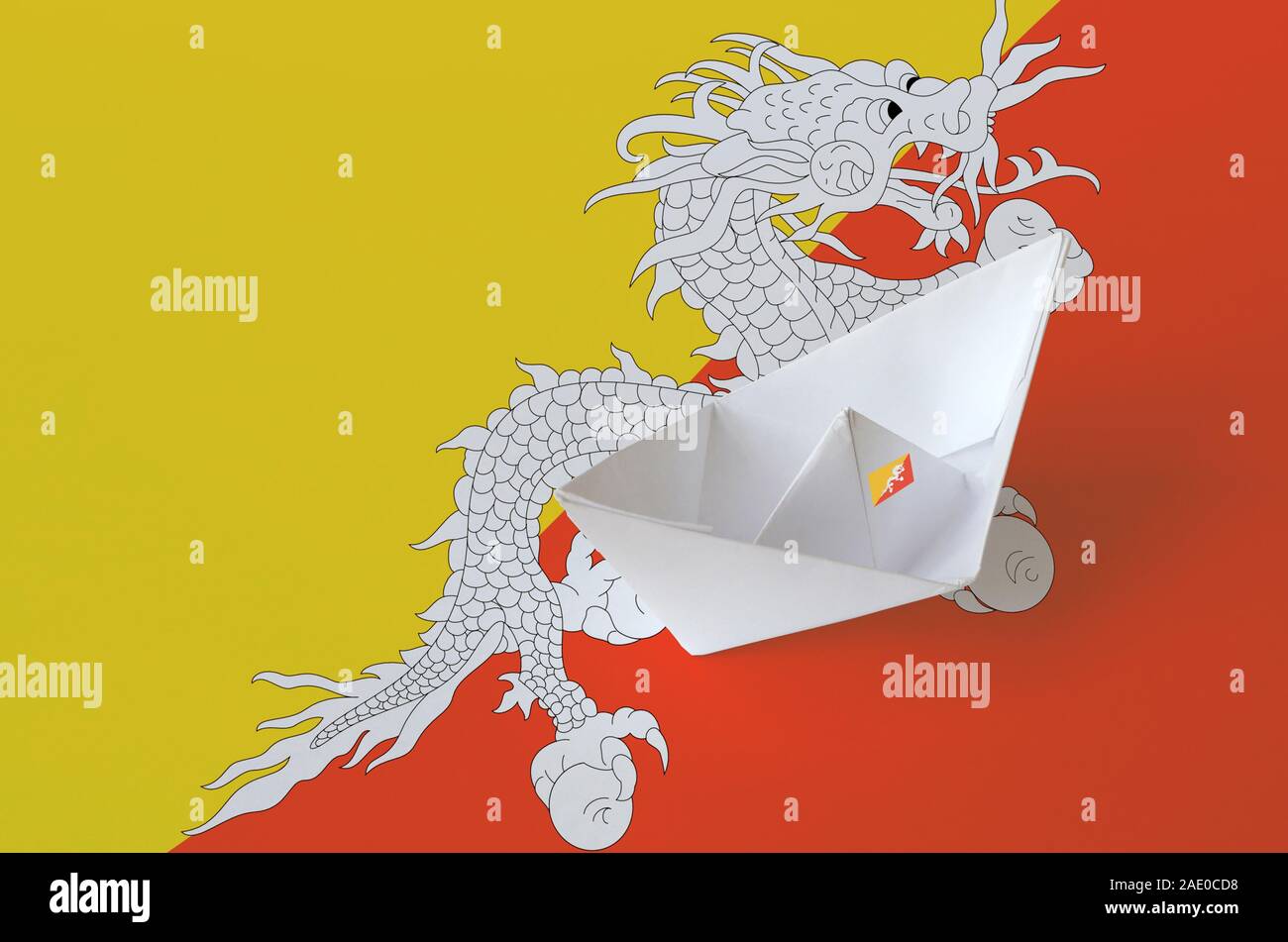 Bhutan flag depicted on paper origami ship closeup. Oriental handmade ...
