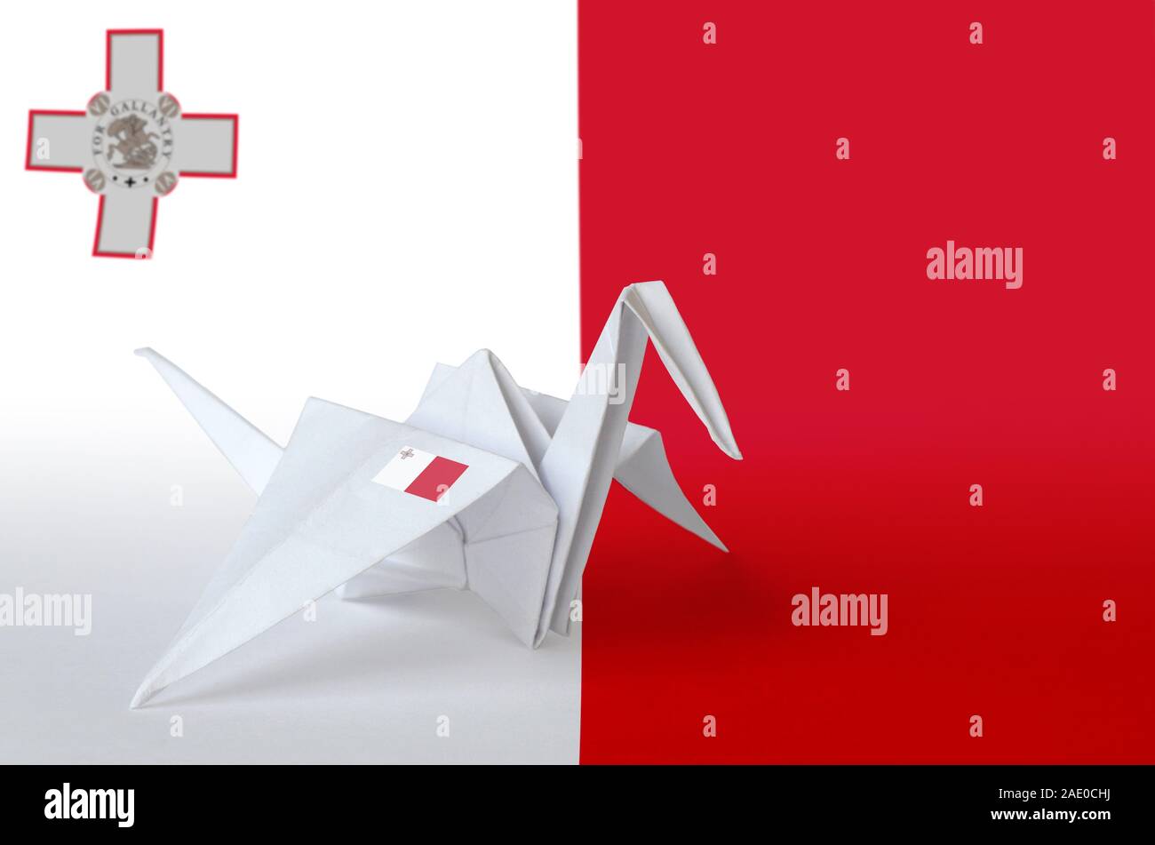 Malta flag depicted on paper origami crane wing. Oriental handmade arts ...