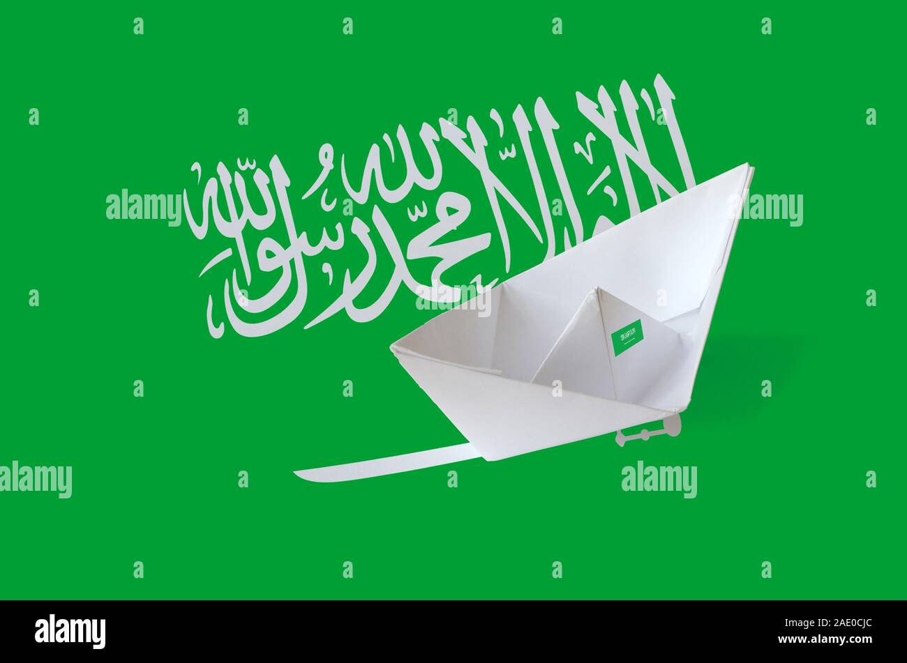 Saudi Arabia flag depicted on paper origami ship closeup. Oriental ...