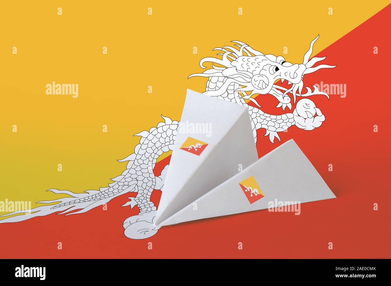 Bhutan flag depicted on paper origami airplane. Oriental handmade arts ...