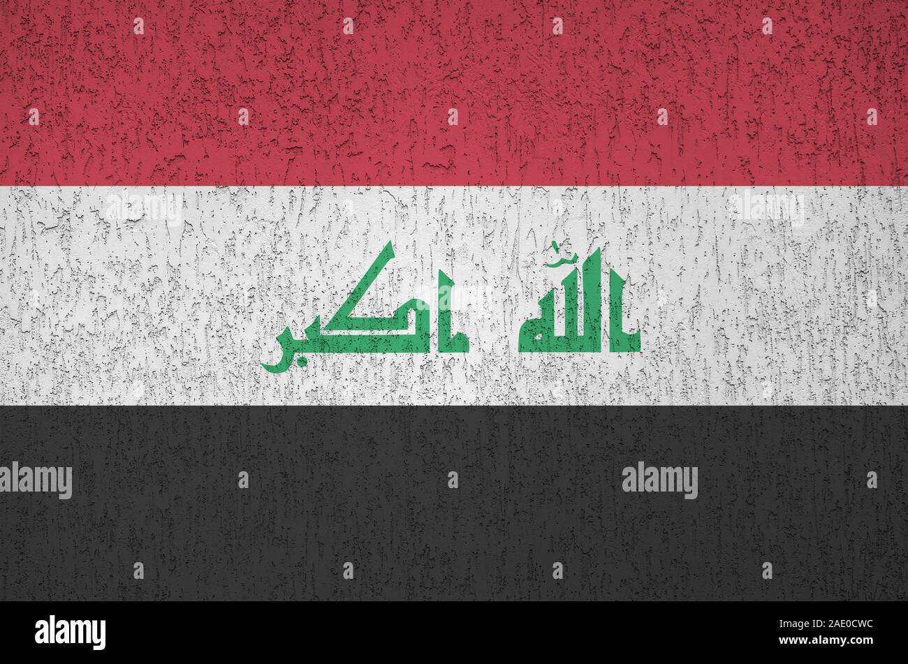 Iraq flag depicted in bright paint colors on old relief plastering wall ...