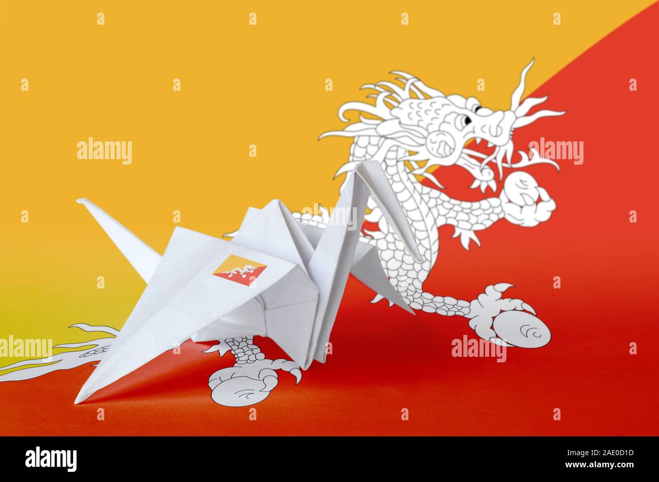 Bhutan flag depicted on paper origami crane wing. Oriental handmade ...