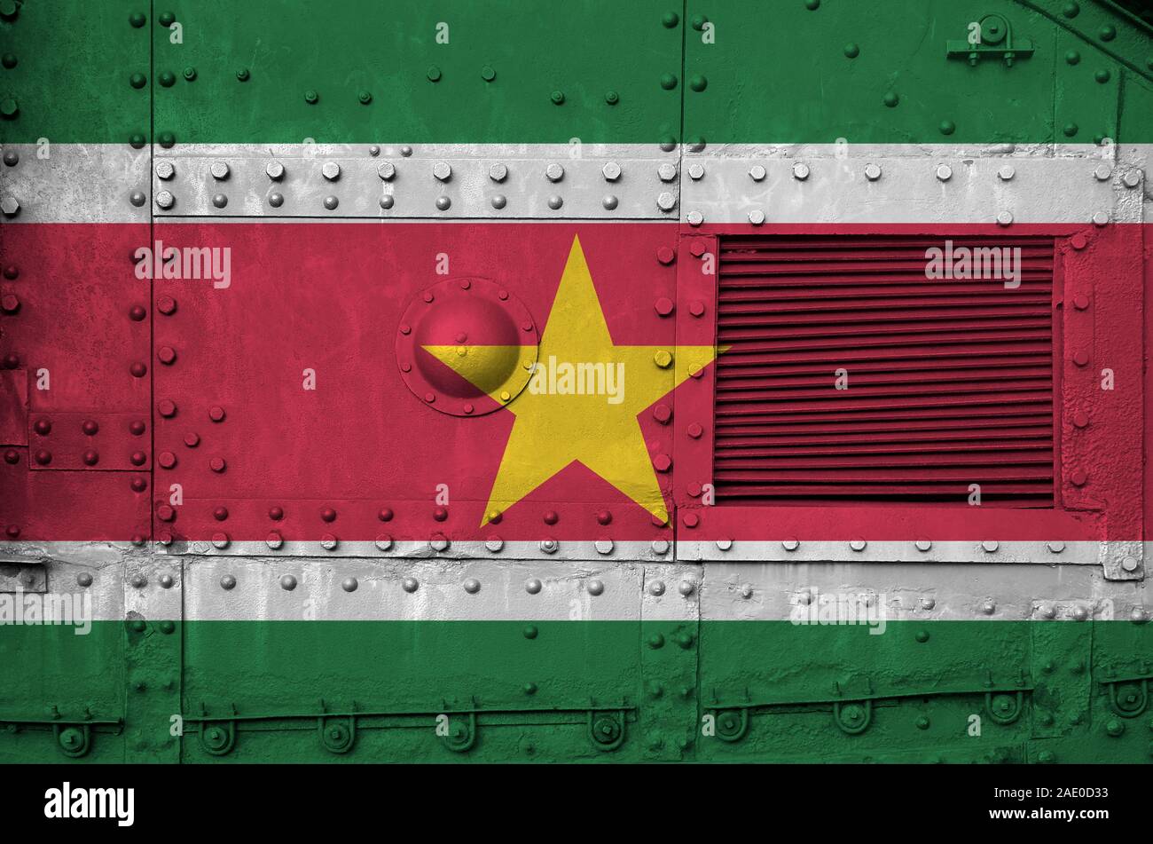 Suriname flag depicted on side part of military armored tank close up ...