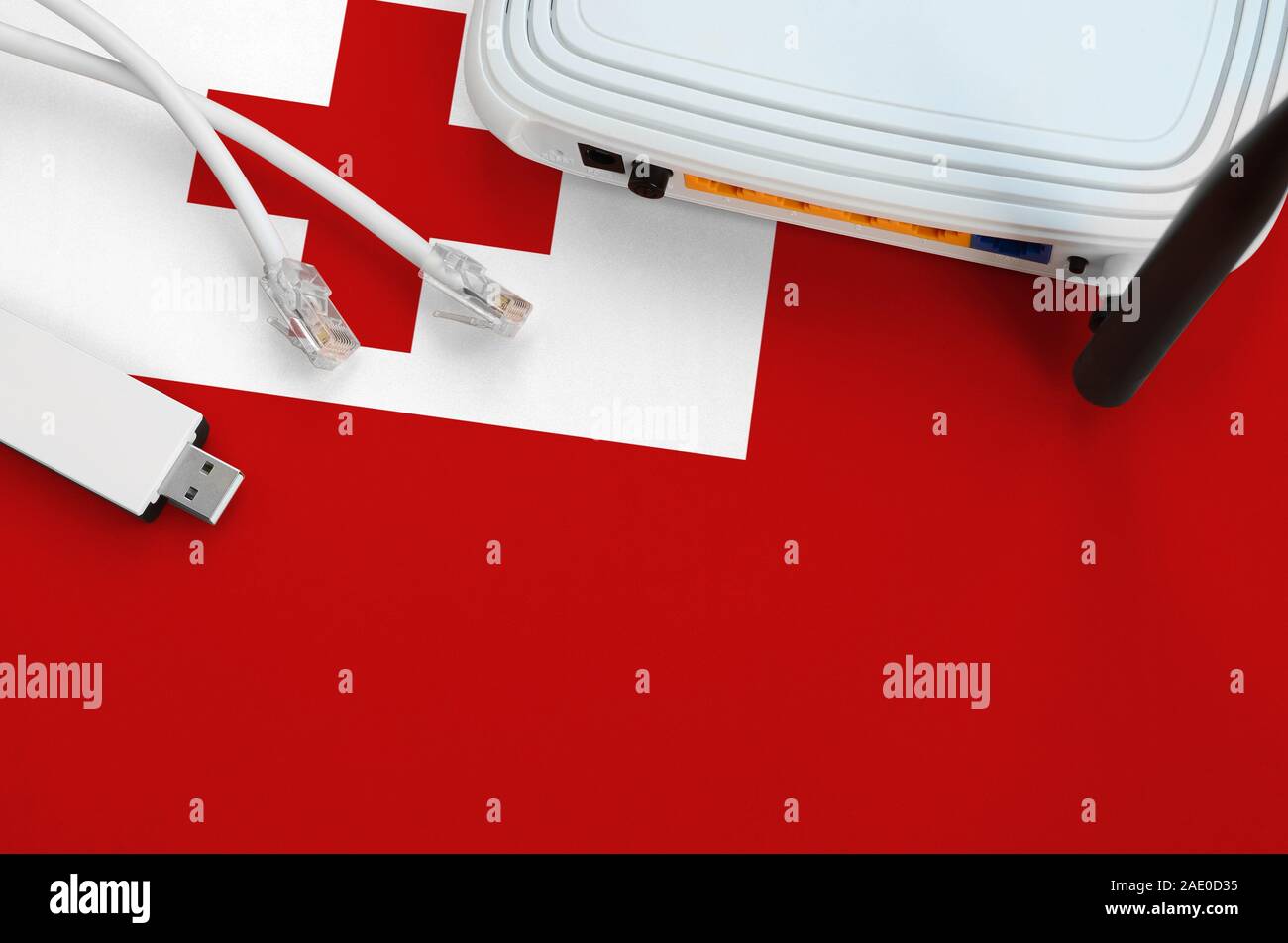 Tonga flag depicted on table with internet rj45 cable, wireless usb wi ...