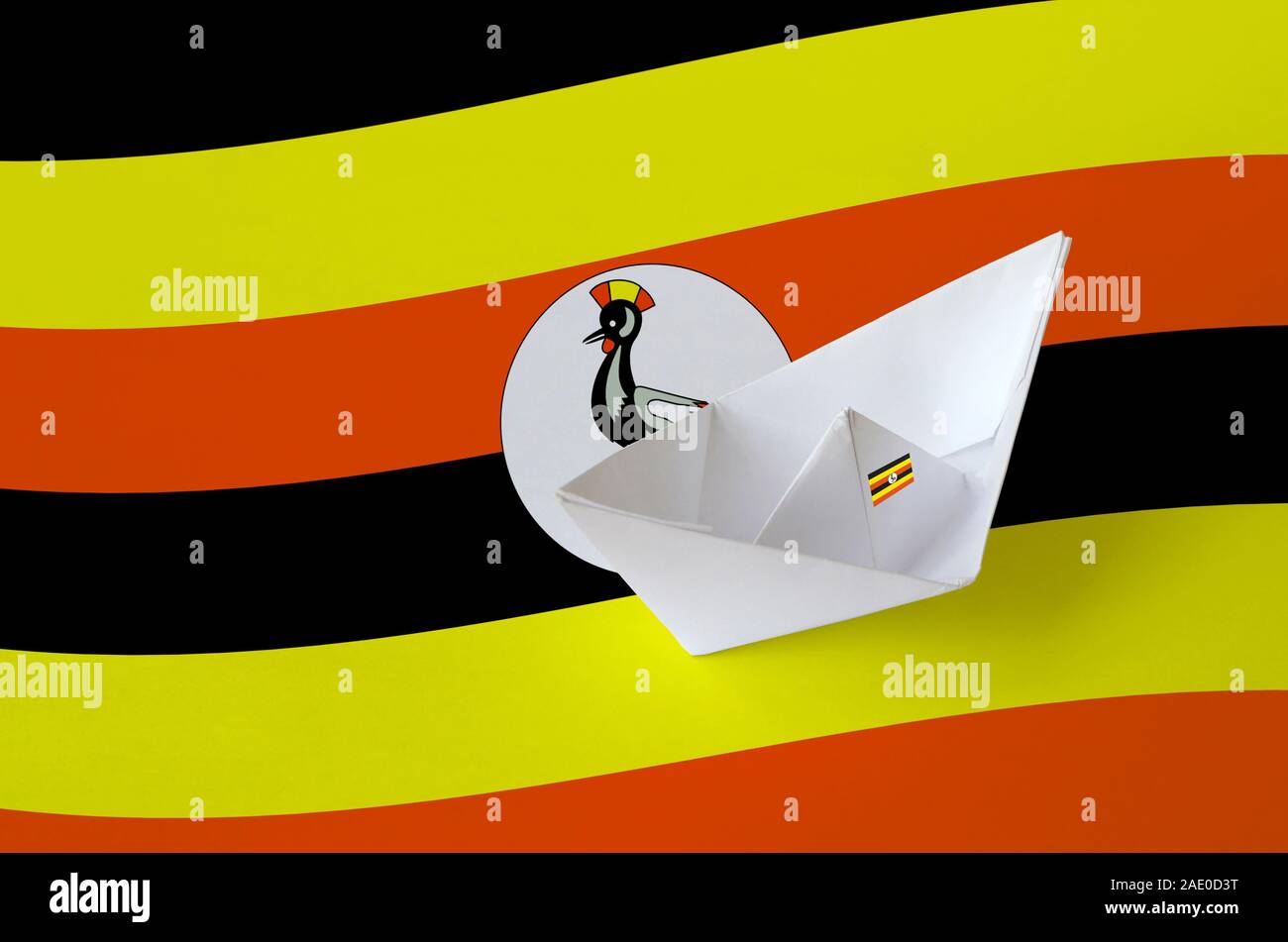 Uganda flag depicted on paper origami ship closeup. Oriental handmade ...