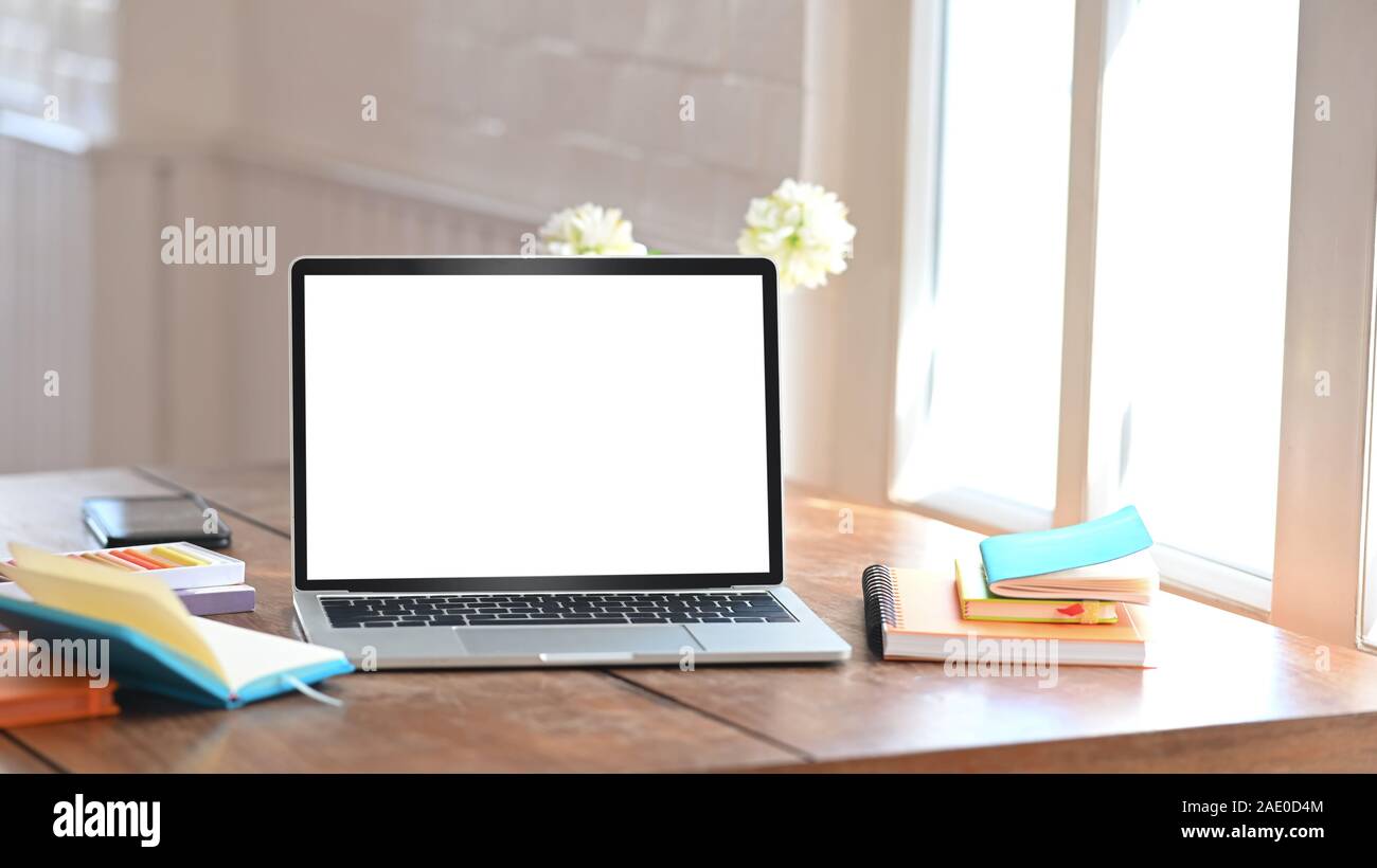 Mockup laptop computer isolated white screen on creative workspace ...