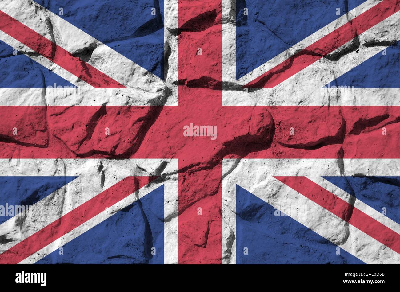 Great britain flag depicted in paint colors on old stone wall close up ...