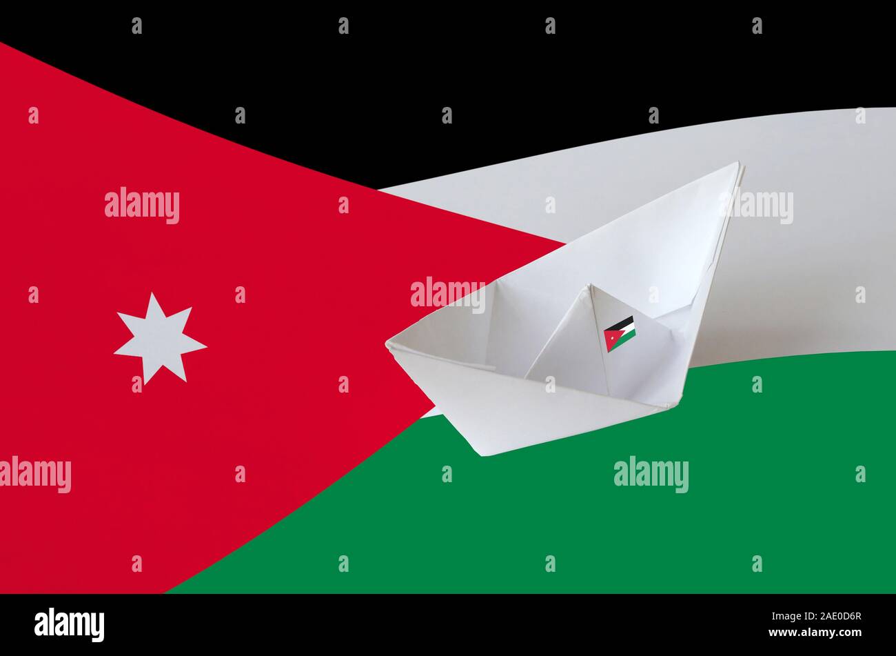 Jordan flag depicted on paper origami ship closeup. Oriental handmade ...