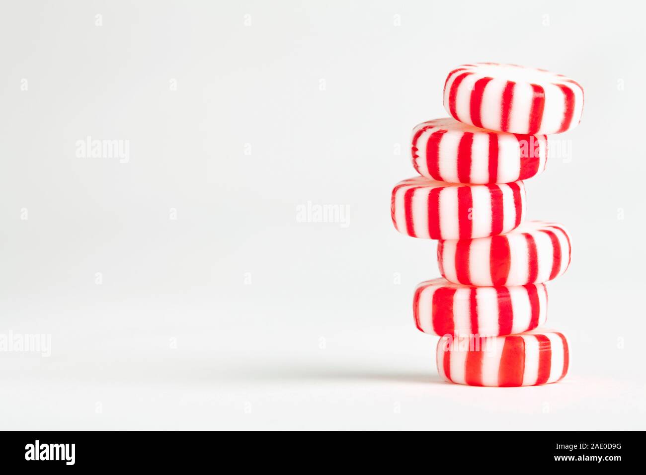 Tall uneven stack of multiple peppermint candies Stock Photo - Alamy