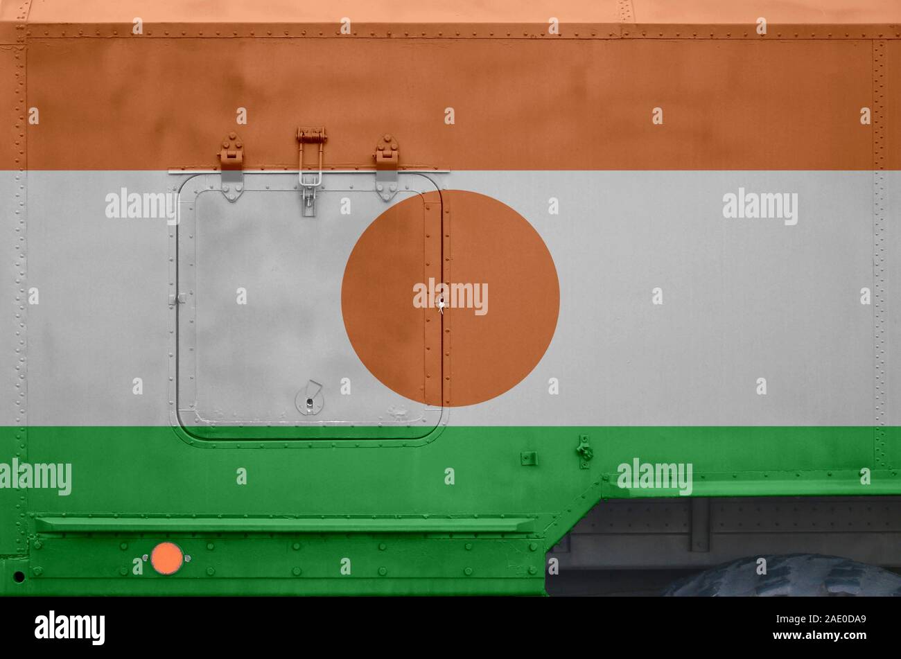 Niger flag depicted on side part of military armored truck close up ...