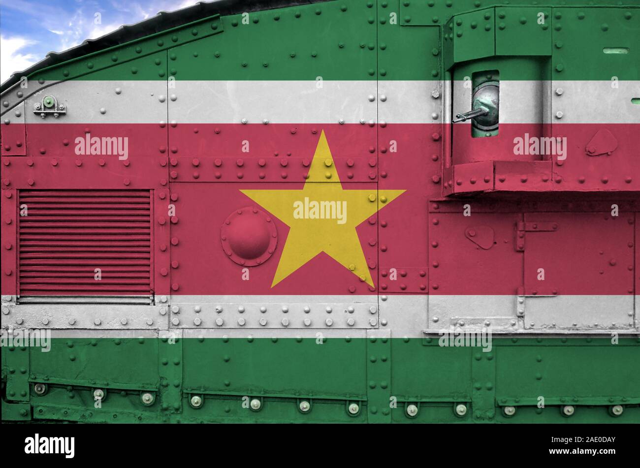 Suriname flag depicted on side part of military armored tank close up ...