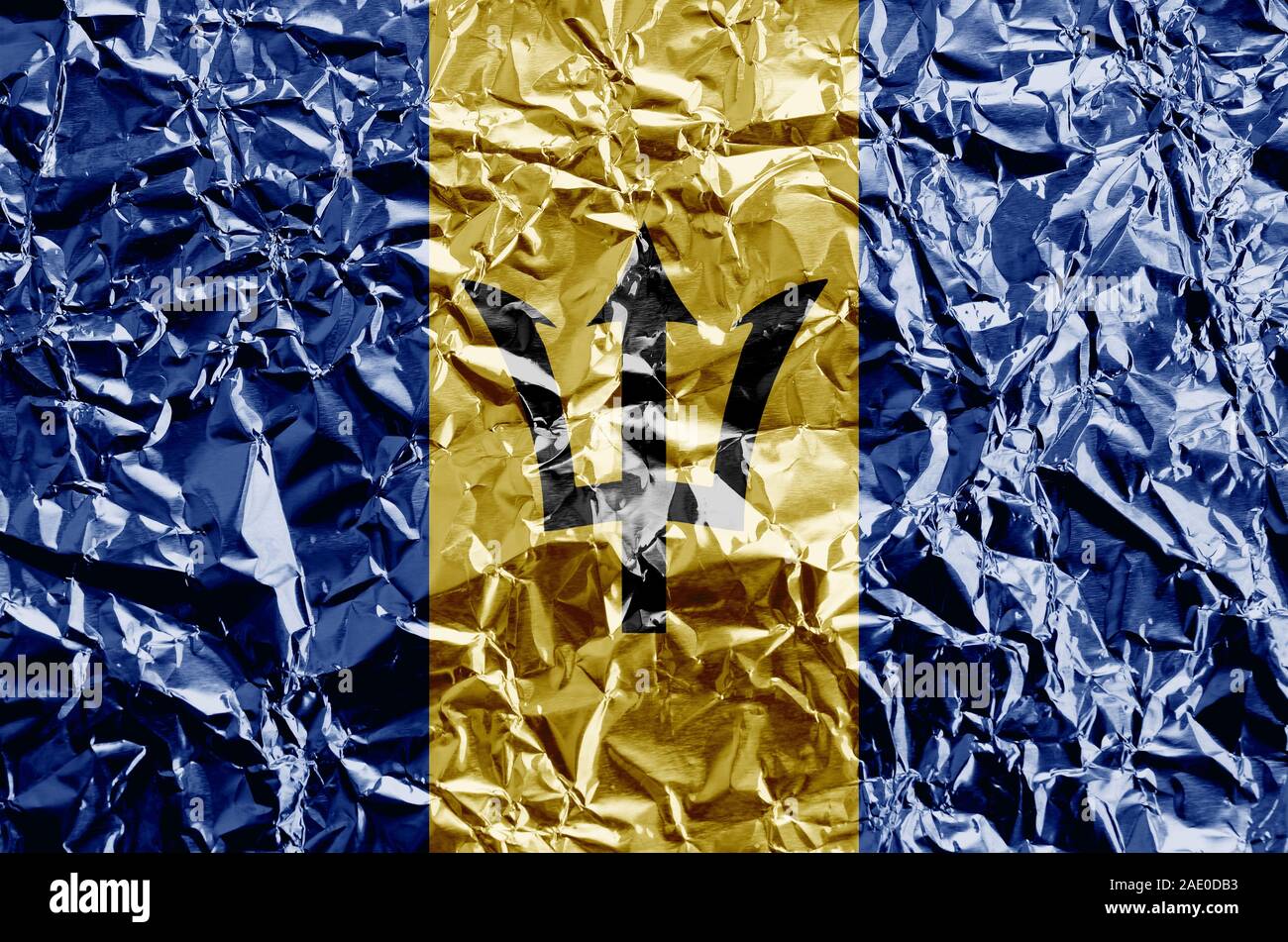 Barbados flag depicted in paint colors on shiny crumpled aluminium foil ...