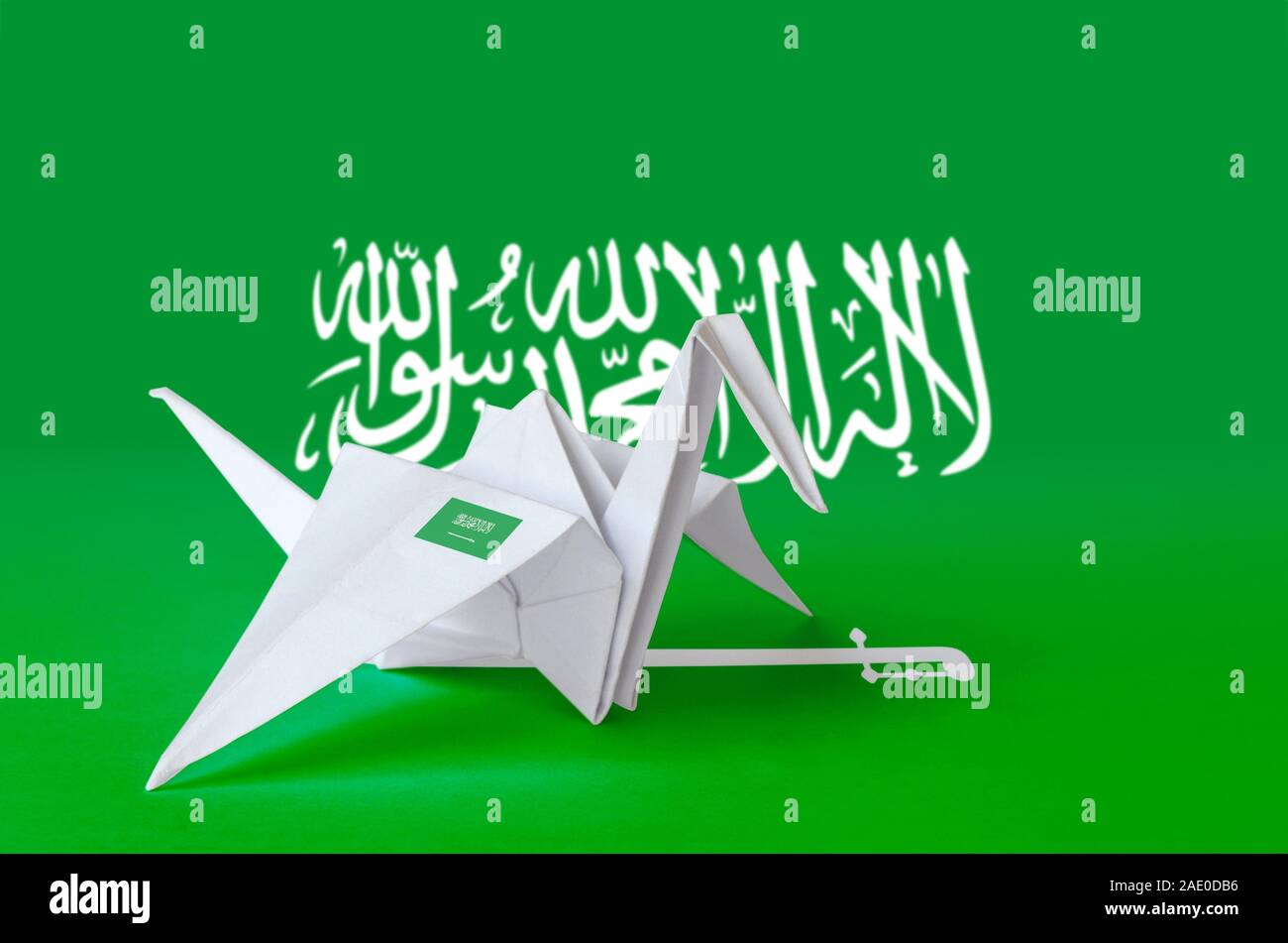 Saudi Arabia flag depicted on paper origami crane wing. Oriental ...