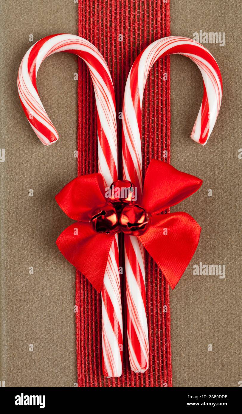 Two candy canes and ribbon on a wrapped holiday gift Stock Photo - Alamy