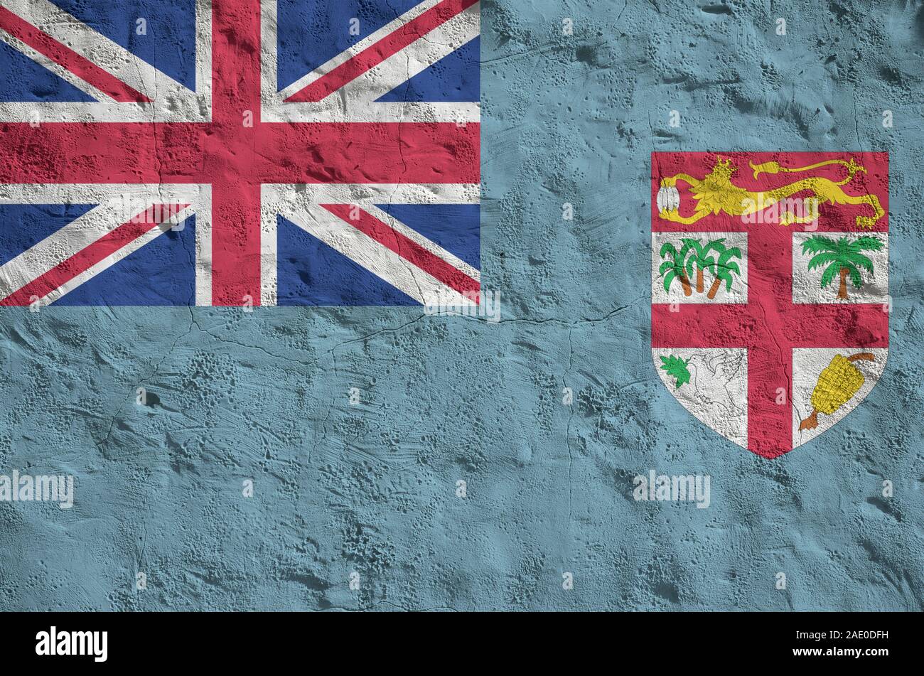 Fiji flag depicted in bright paint colors on old relief plastering wall ...