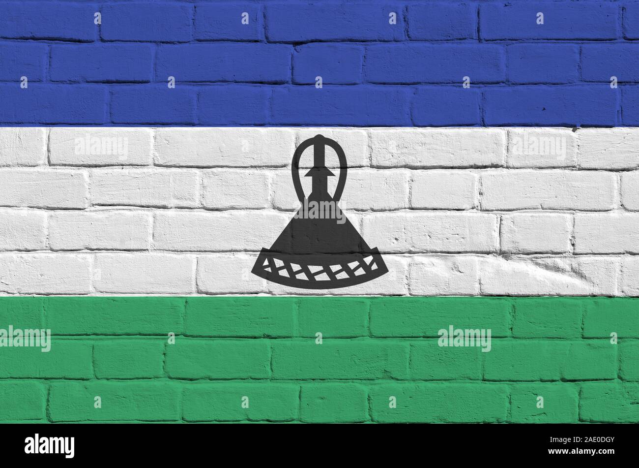 Lesotho flag depicted in paint colors on old brick wall close up ...