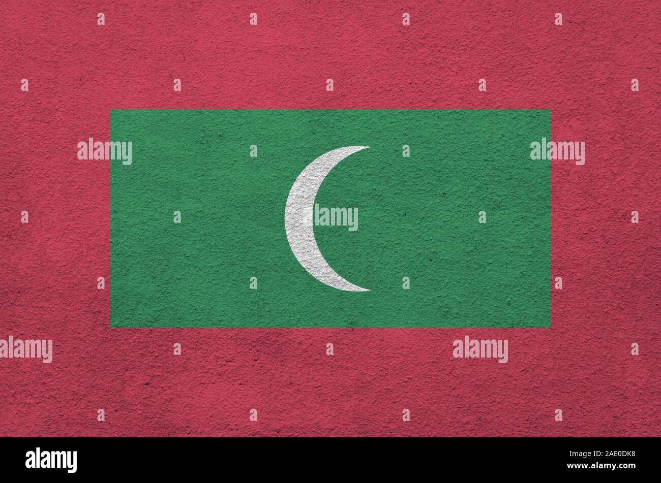 Maldives flag depicted in bright paint colors on old relief plastering ...