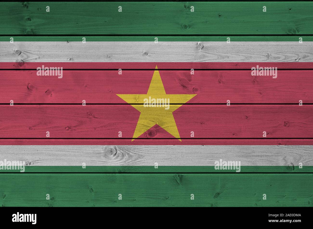 Suriname flag depicted in bright paint colors on old wooden wall close ...