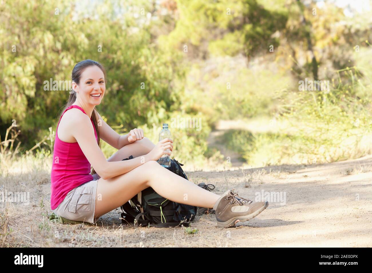 Woman taking a water break from hiking Stock Photo - Alamy