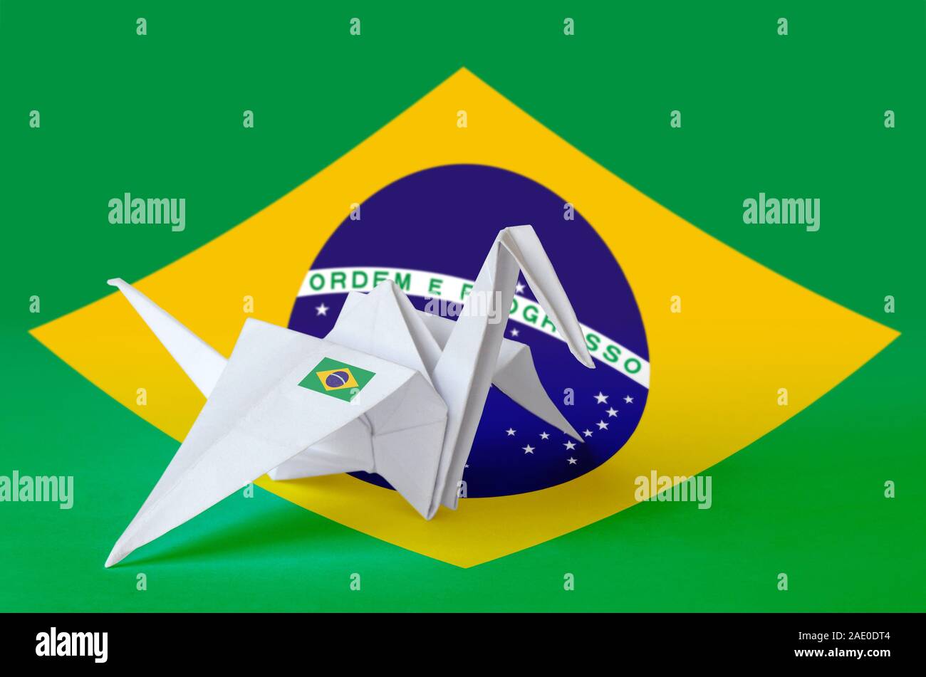 Brazil flag depicted on paper origami crane wing. Oriental handmade ...