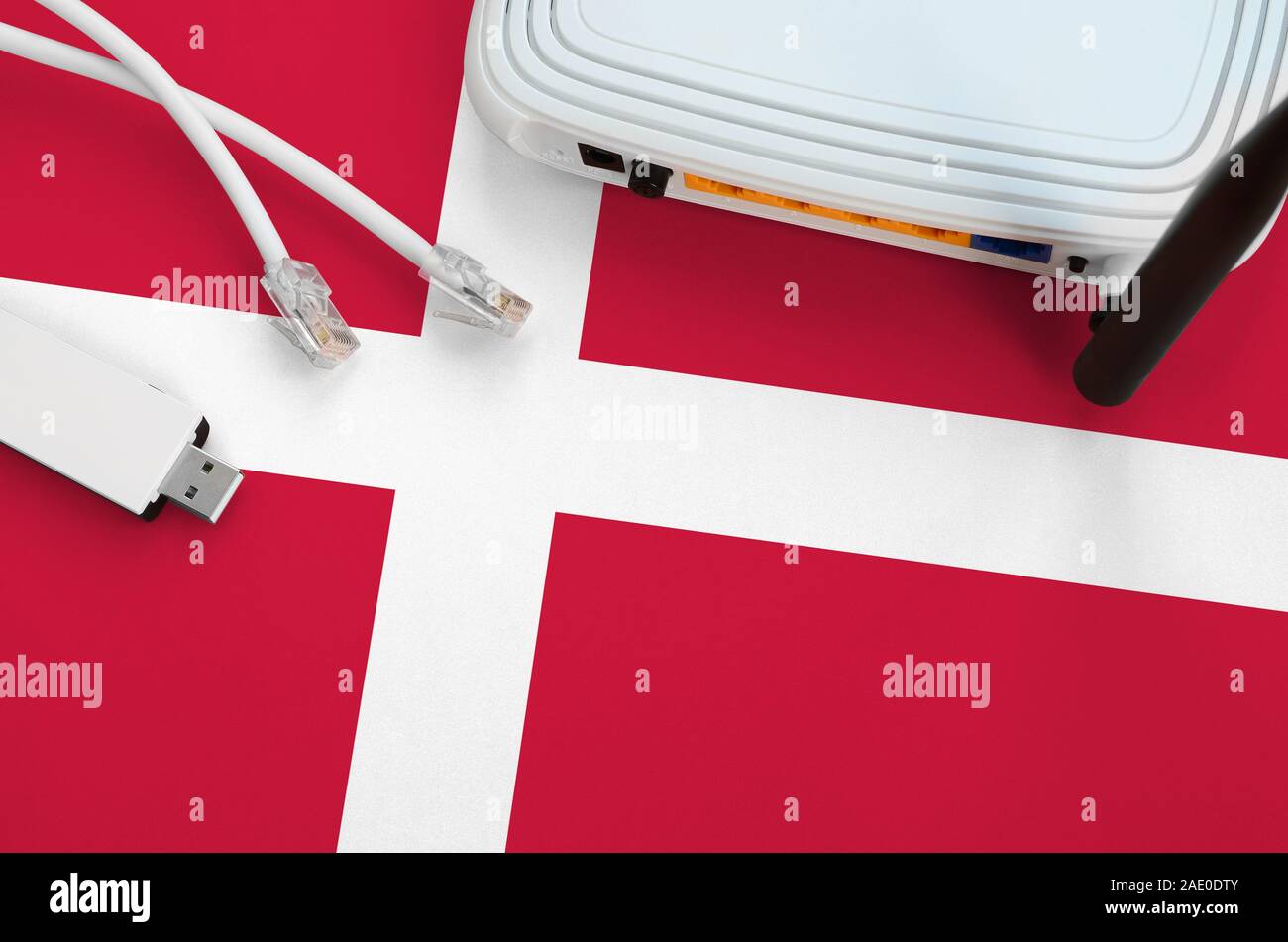 Denmark flag depicted on table with internet rj45 cable, wireless usb ...