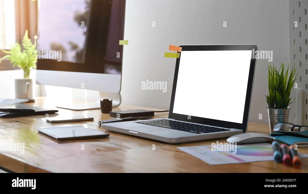 Side view mockup laptop computer on creative graphic design workspace ...