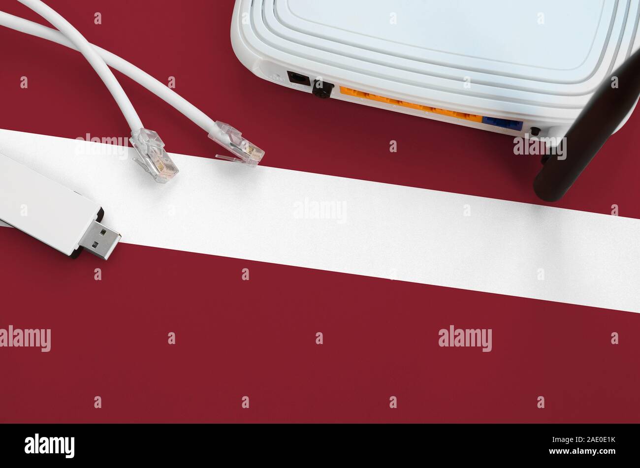 Latvia flag depicted on table with internet rj45 cable, wireless usb wi ...
