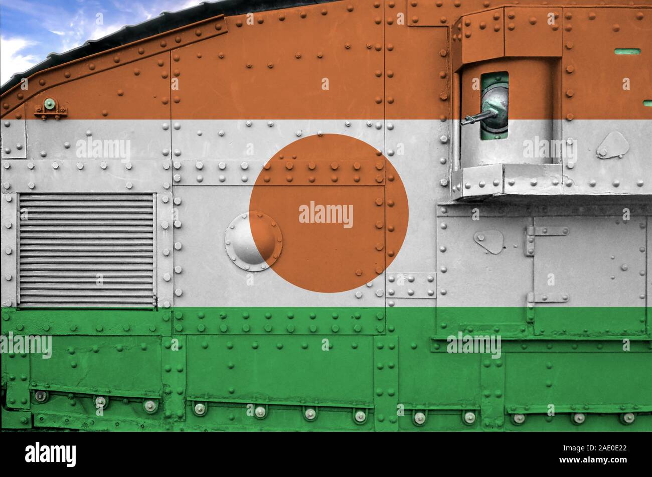Niger flag depicted on side part of military armored tank close up ...